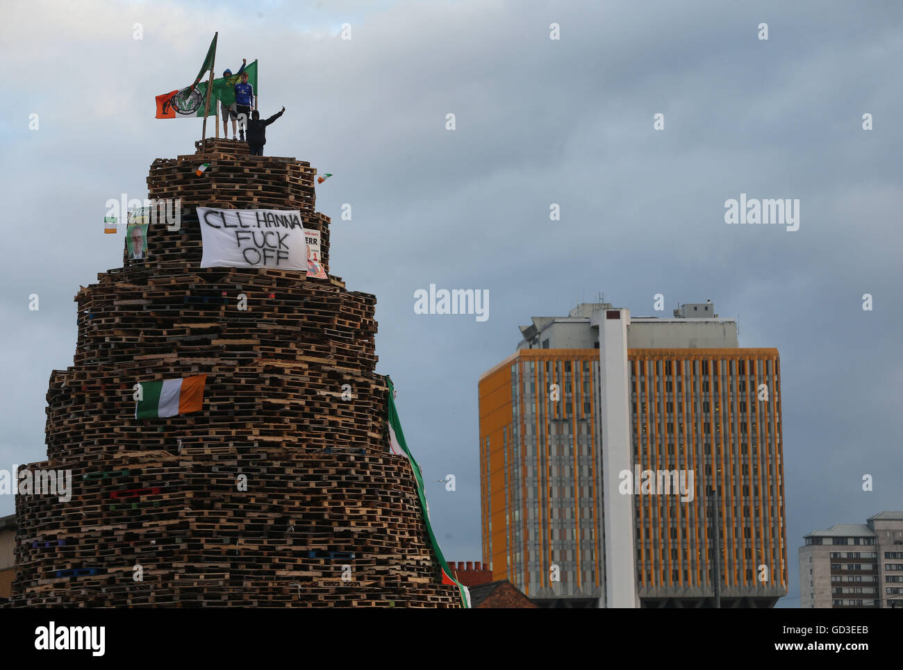 NOTE LANGUAGE ON BANNERS Children atop the huge bonfire in Sandy Row ...