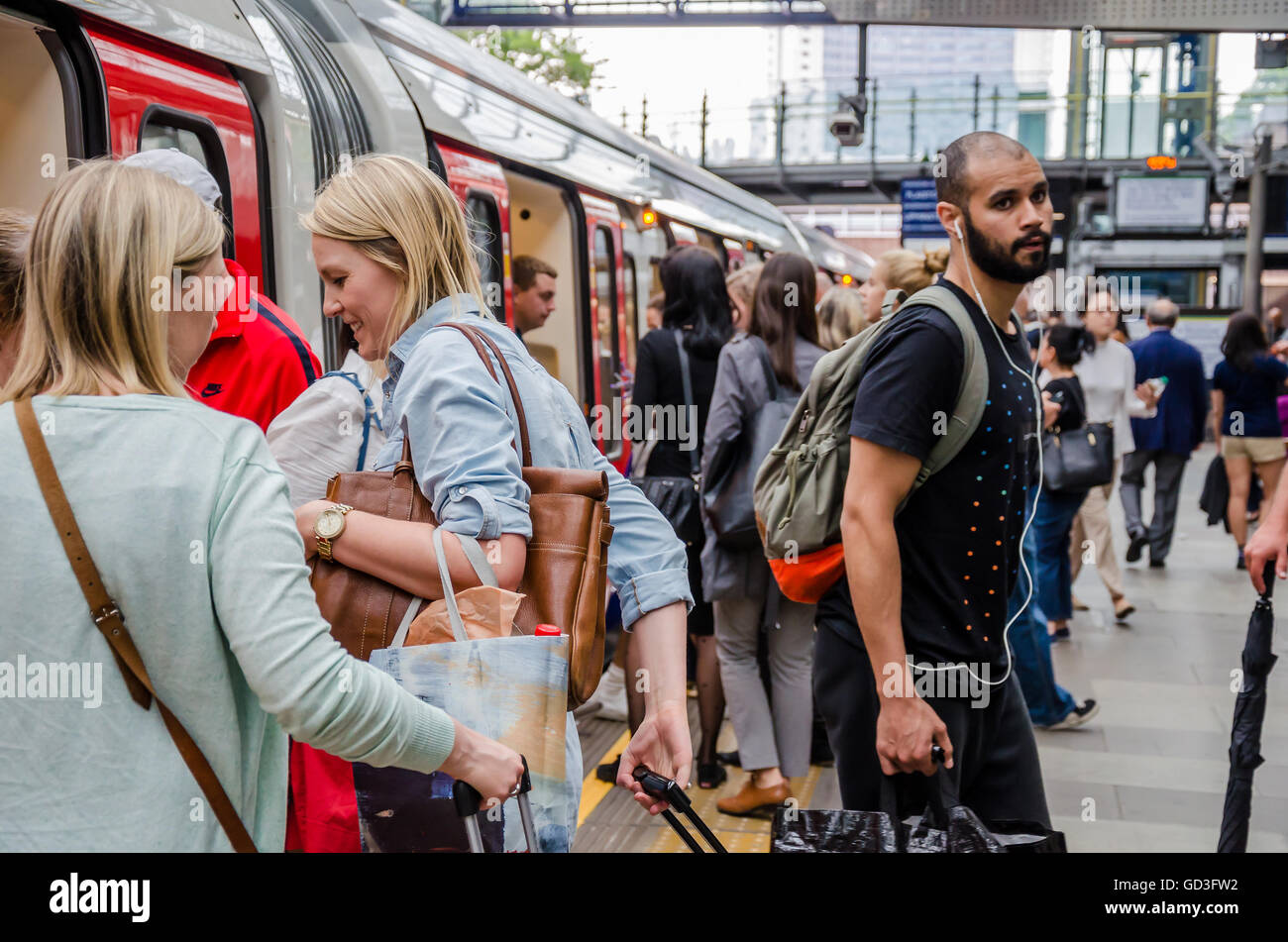 People disembark and board a London Underground train at Earl's Court ...
