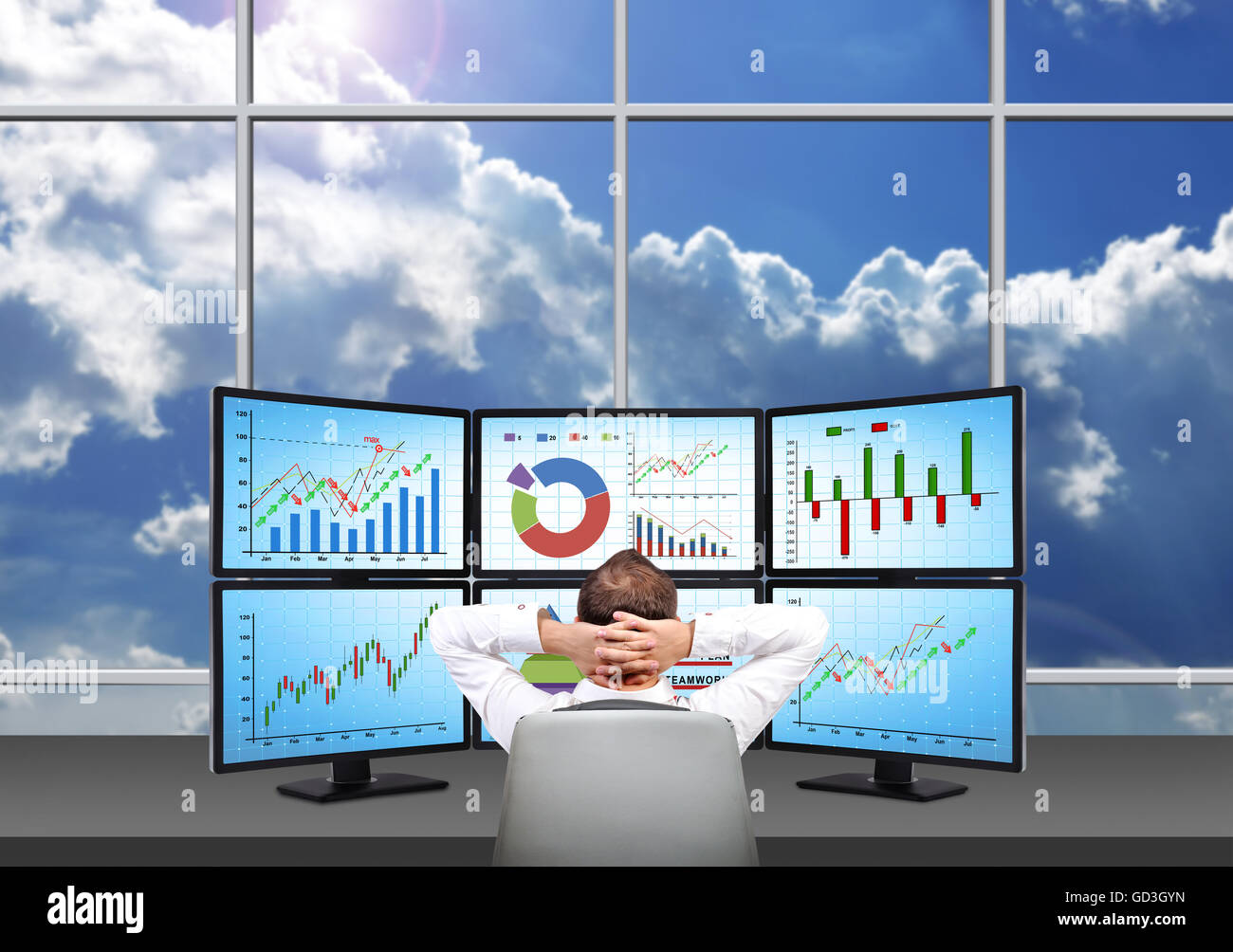 relaxing trader who is sitting in front of a trading station which ...