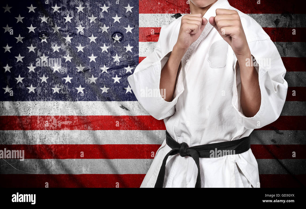 karate fighter in kimono on american flag background Stock Photo - Alamy
