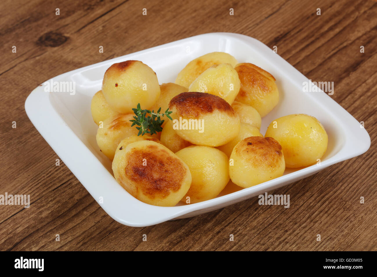 Golden backed potato with thyme branch Stock Photo - Alamy
