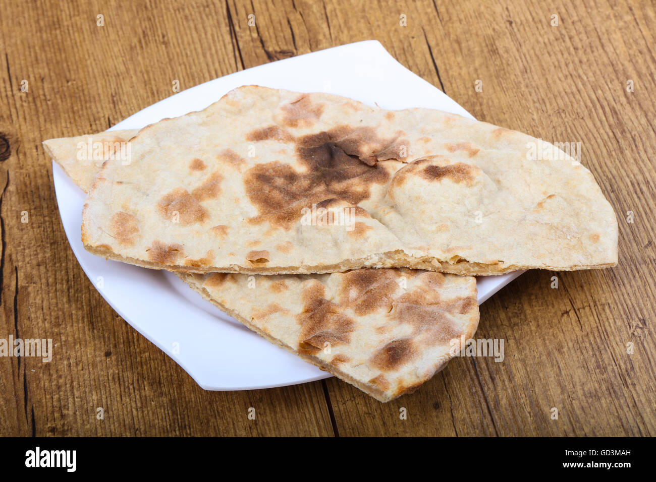 Indian bread naan in the plate on wood background Stock Photo - Alamy
