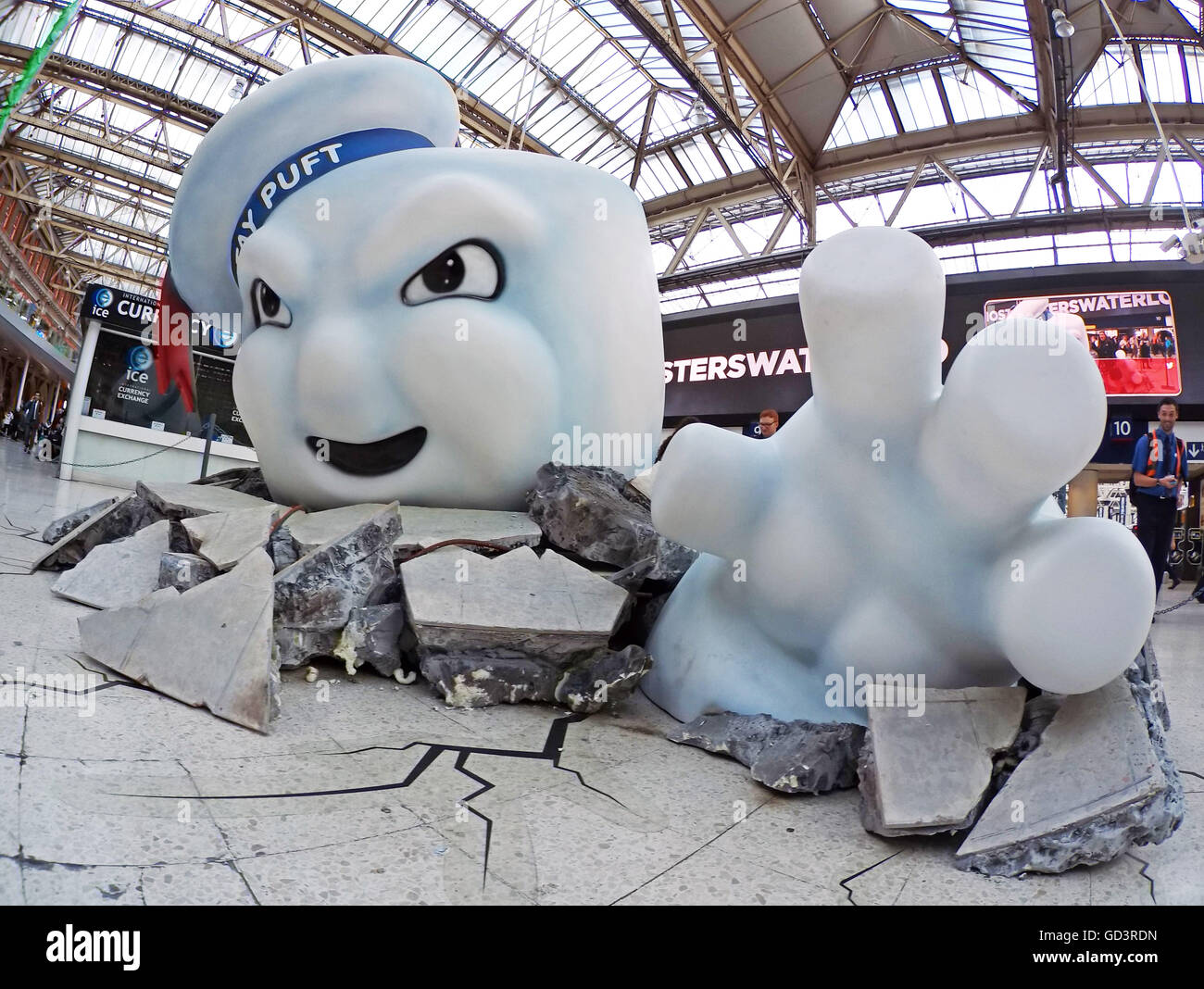 The giant Marshmallow Man from Ghostbusters is seen breaking through ...