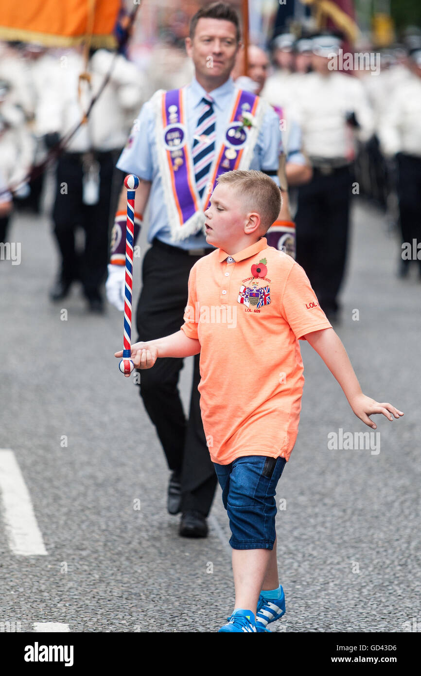 Belfast, UK. 12th July 2016. young boy with twirling red, white and ...