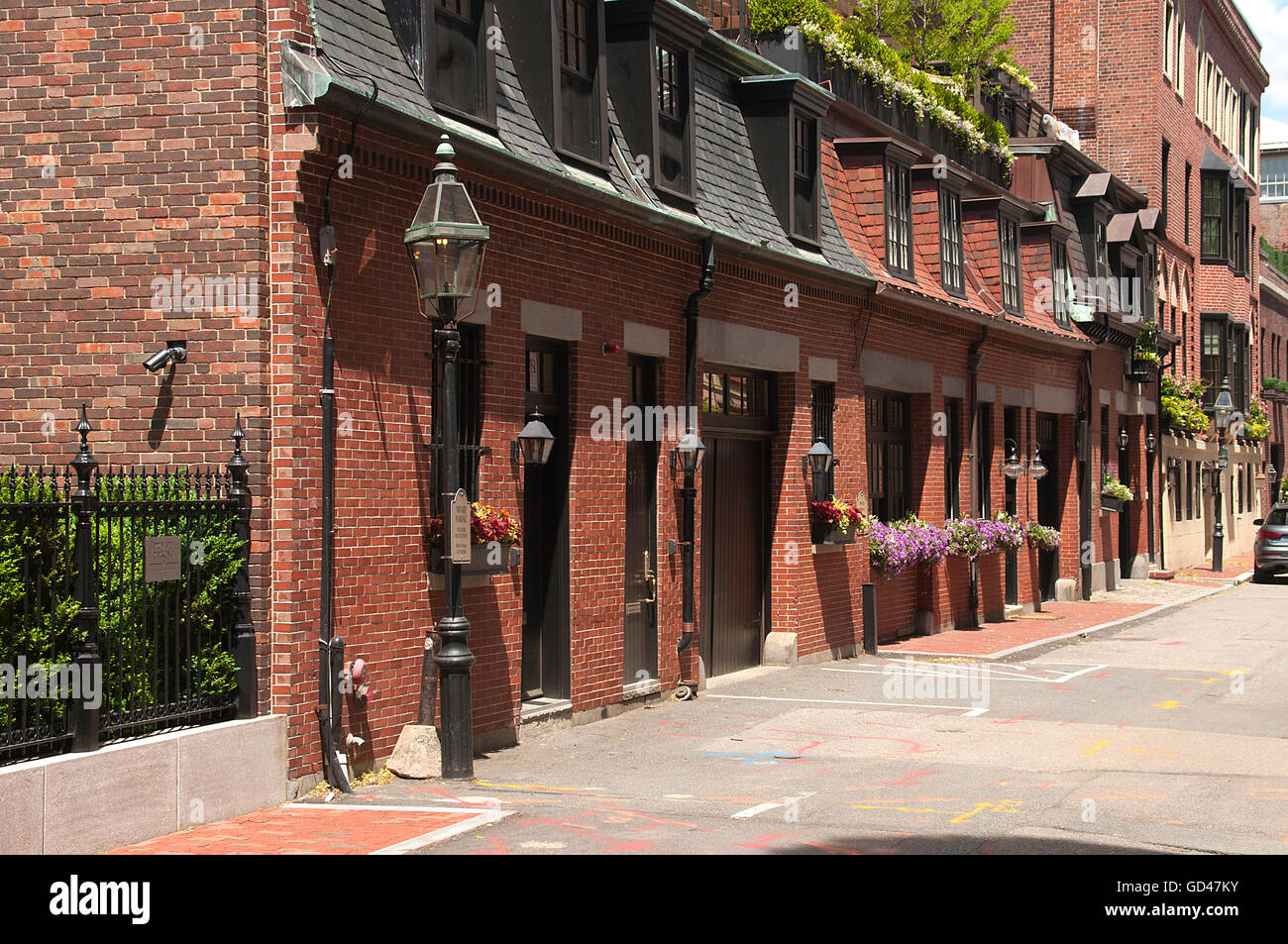 Classic look of old Boston neighborhood. Brick buildings, flowers, and ...