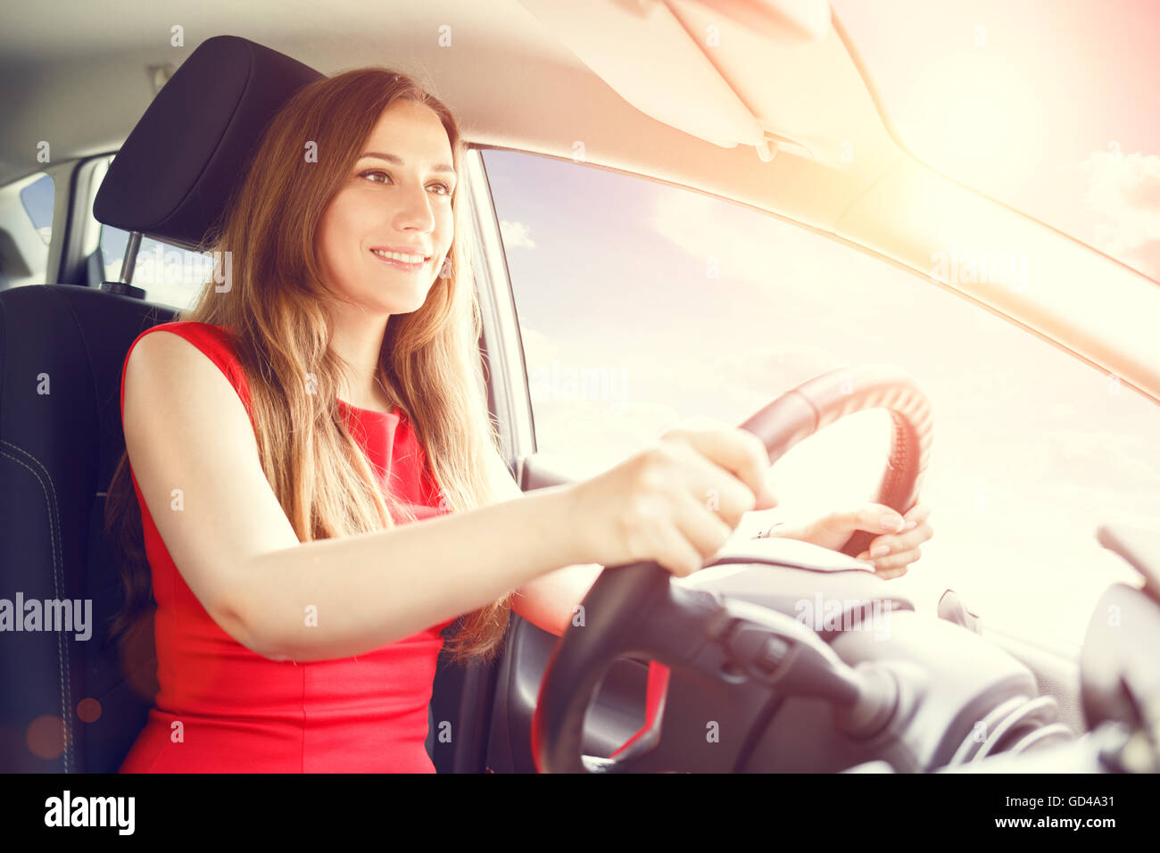 Young beautiful woman steering wheel driving a car. Confident smiling ...
