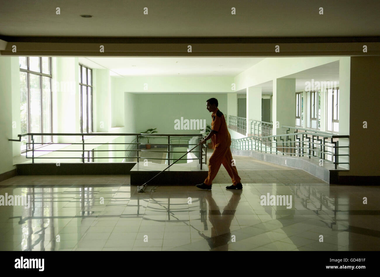 Man sweeping floor Stock Photo - Alamy
