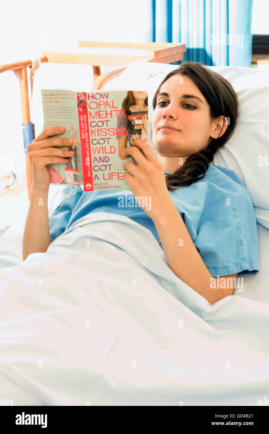 Patient reading book Stock Photo - Alamy