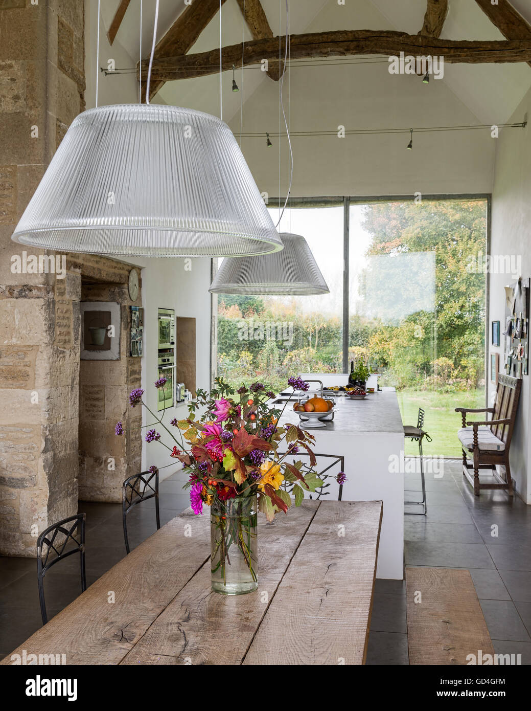 Timber-framed ceiling above refectory style table in kitchen-diner ...