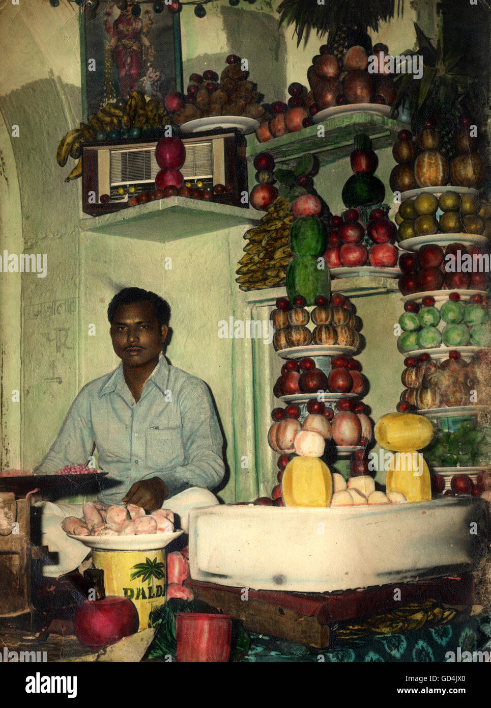 Man sitting in a fruit shop Stock Photo - Alamy
