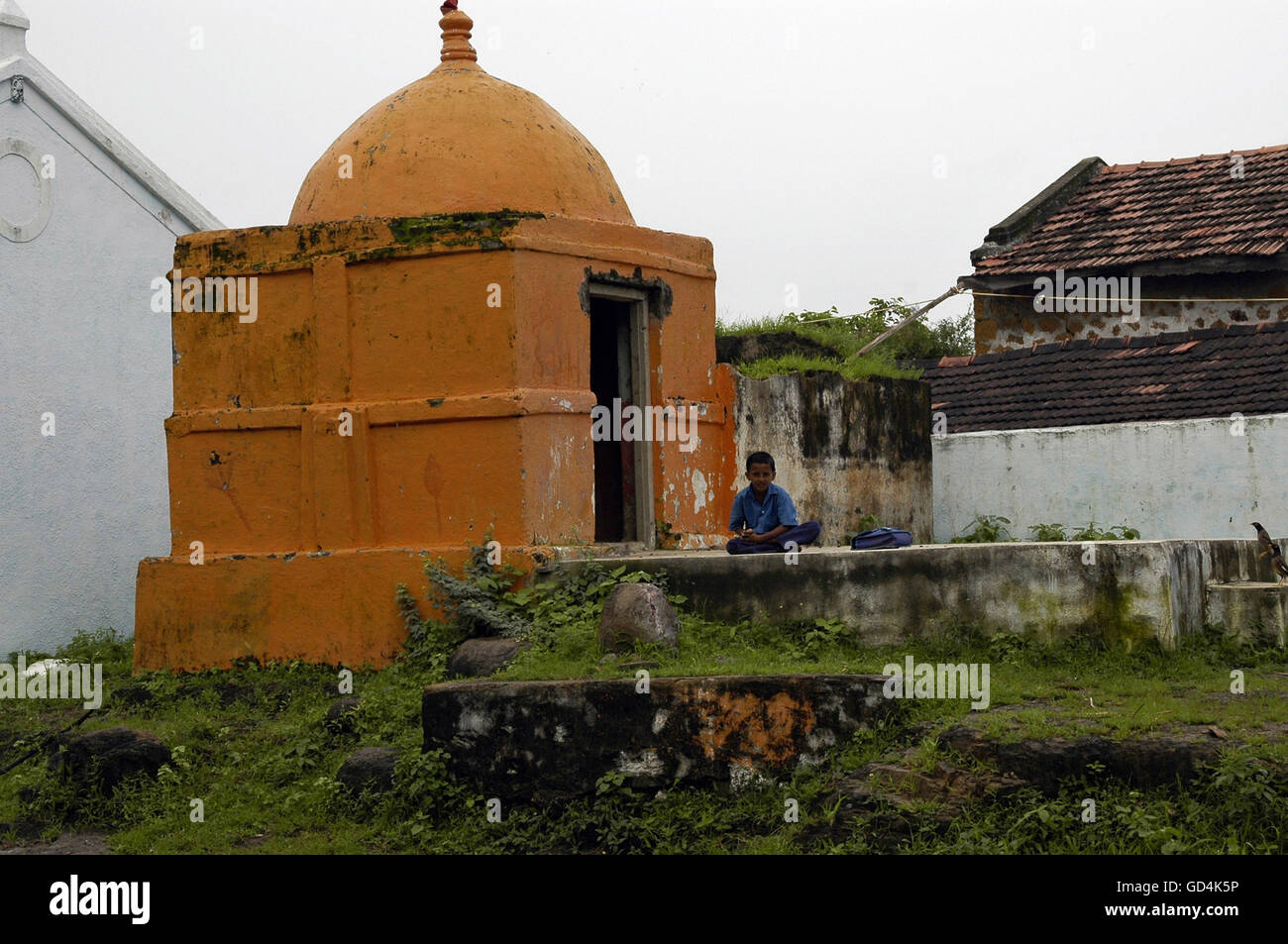 Child sitting outside a temple Stock Photo - Alamy