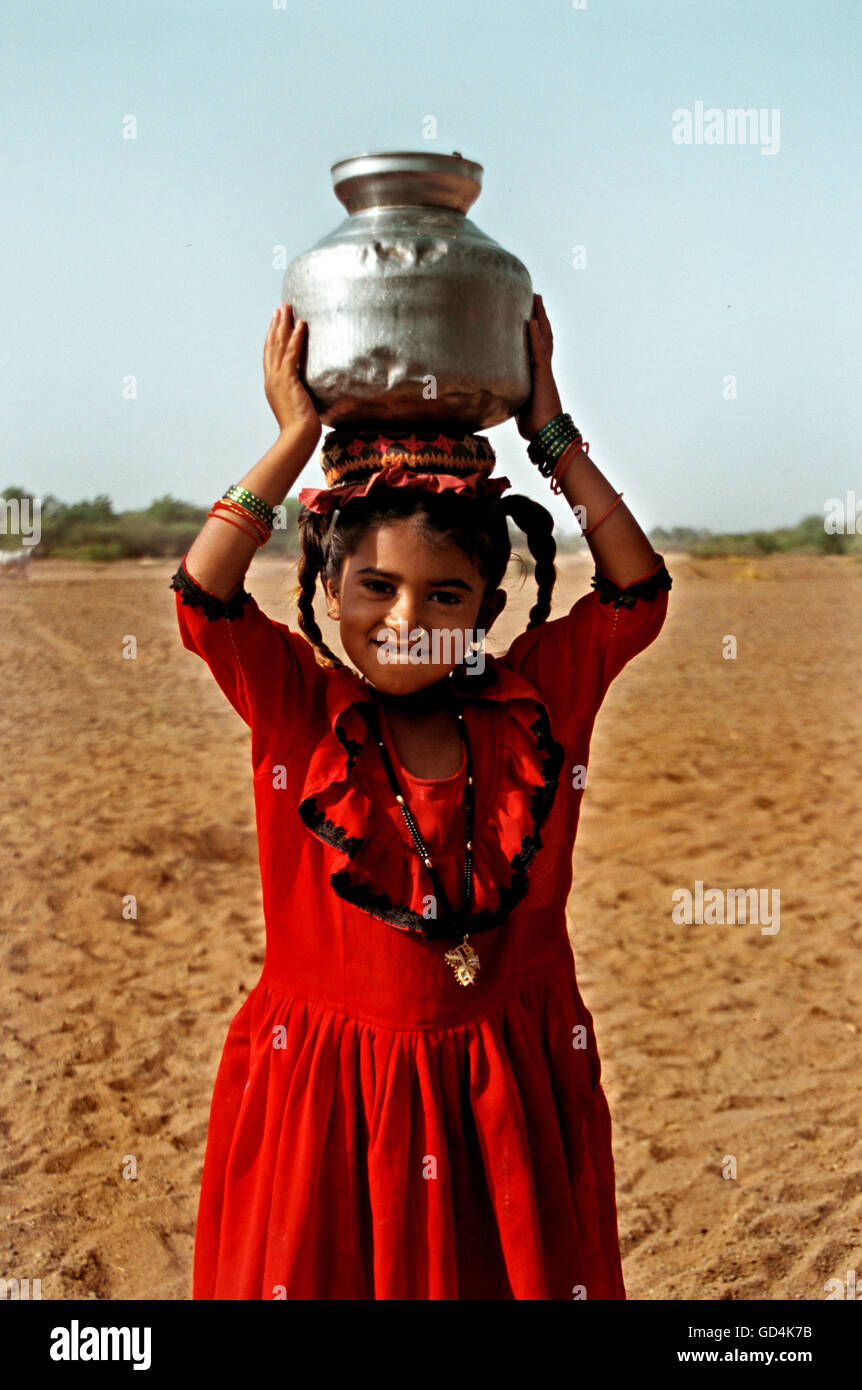 Girl carrying pot Stock Photo - Alamy
