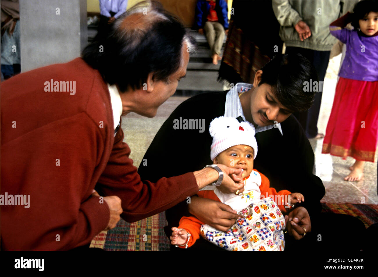 Men with a baby Stock Photo - Alamy