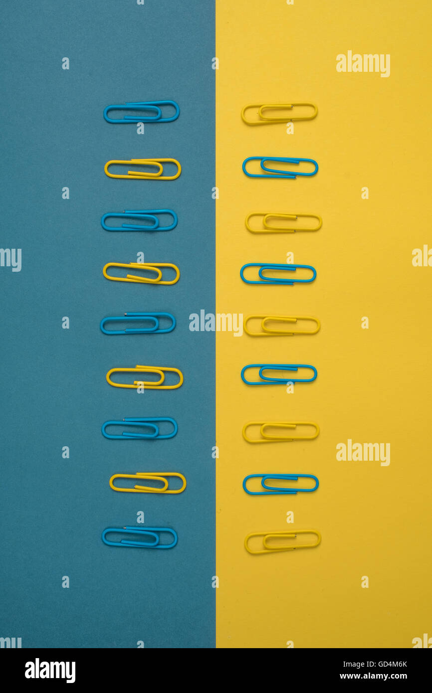 Blue and yellow paper clips Stock Photo - Alamy