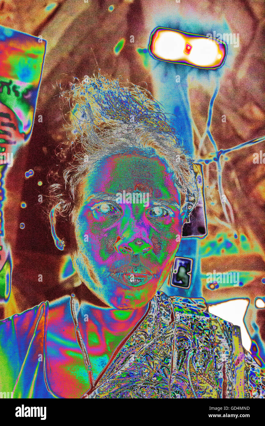 An untouchable woman in her hut, illuminated by an electric light ...