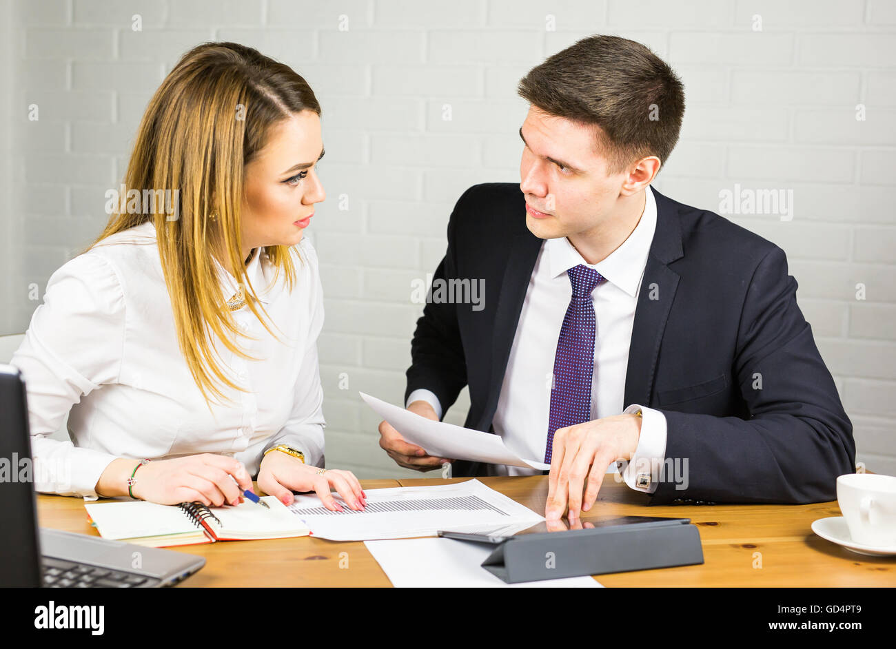 Two business people using tablet computer in office Stock Photo - Alamy