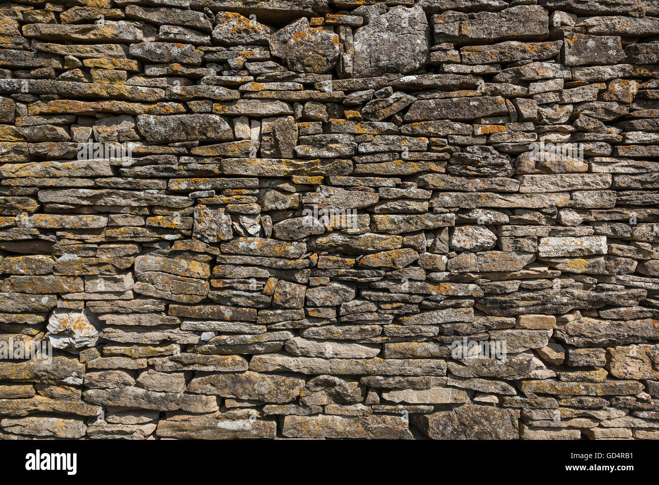 A stone wall of a fence built of old stones Stock Photo - Alamy