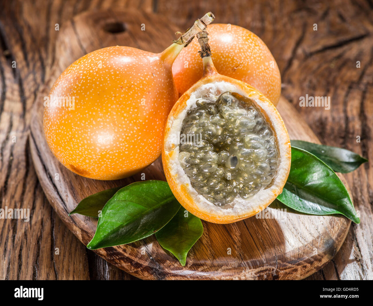 Granadilla fruits on the wooden table Stock Photo - Alamy