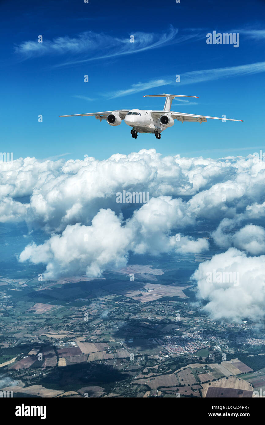 Airplane over the clouds Stock Photo - Alamy
