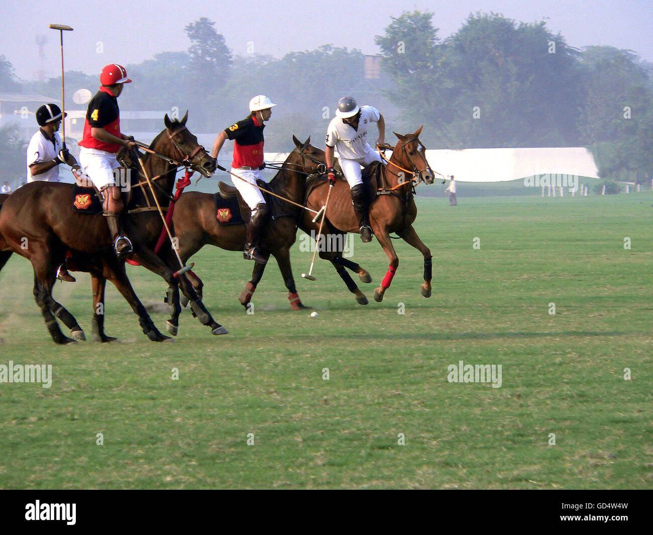 Polo players in action Stock Photo - Alamy