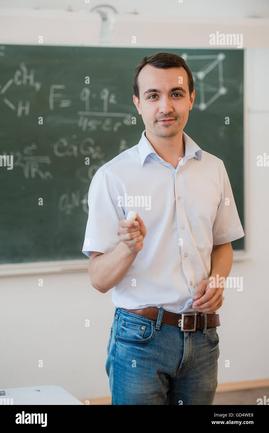 Male teacher standing by blackboard hi-res stock photography and images ...