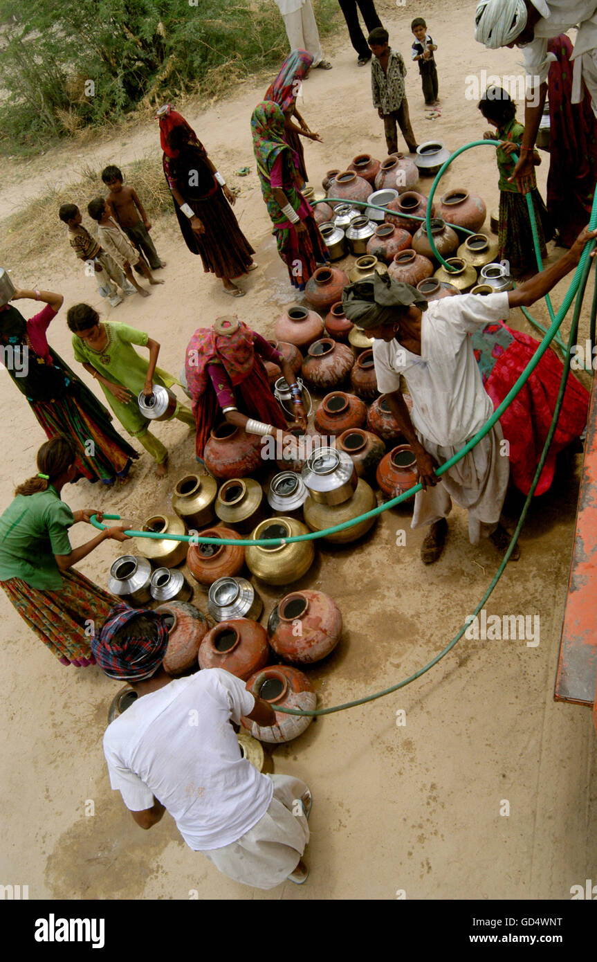 People filling water in pots Stock Photo - Alamy