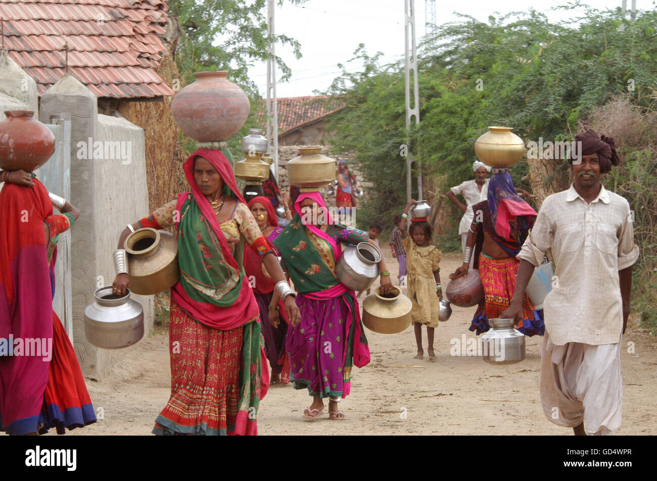 Tribal women carrying pots Stock Photo - Alamy