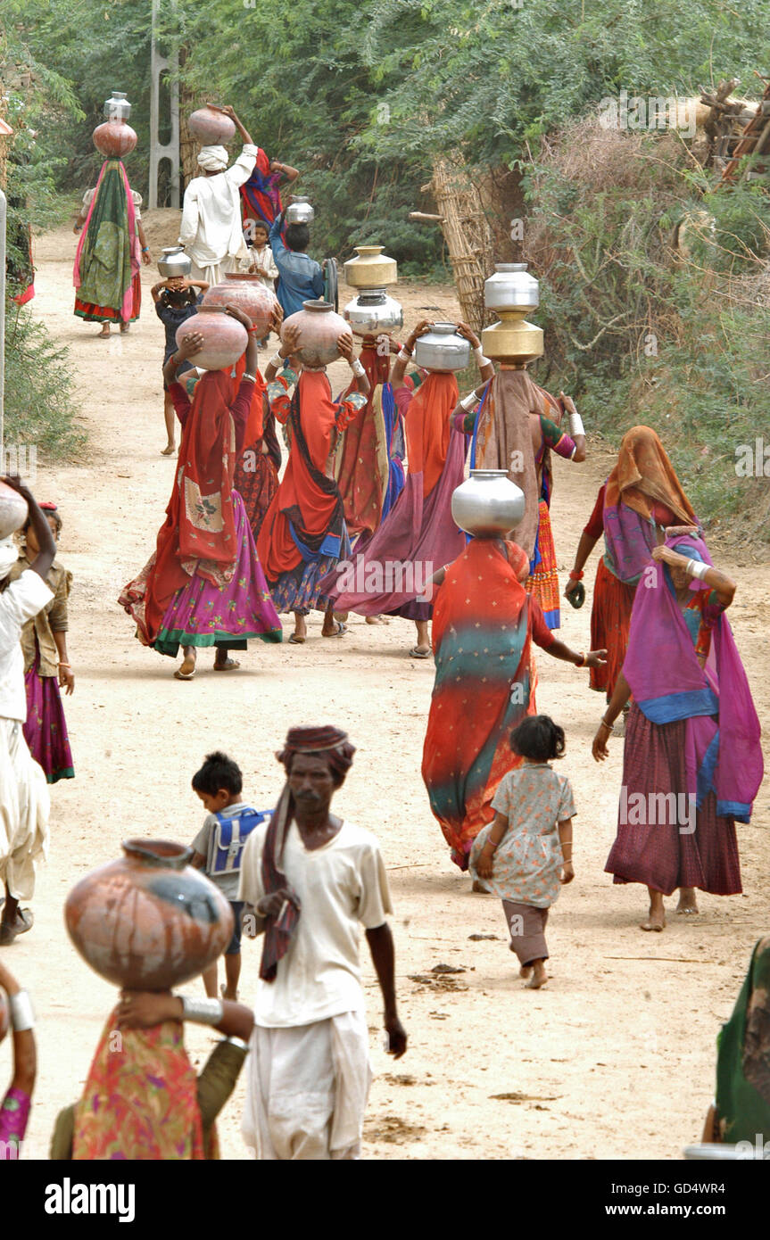 Villagers carrying water pots Stock Photo - Alamy