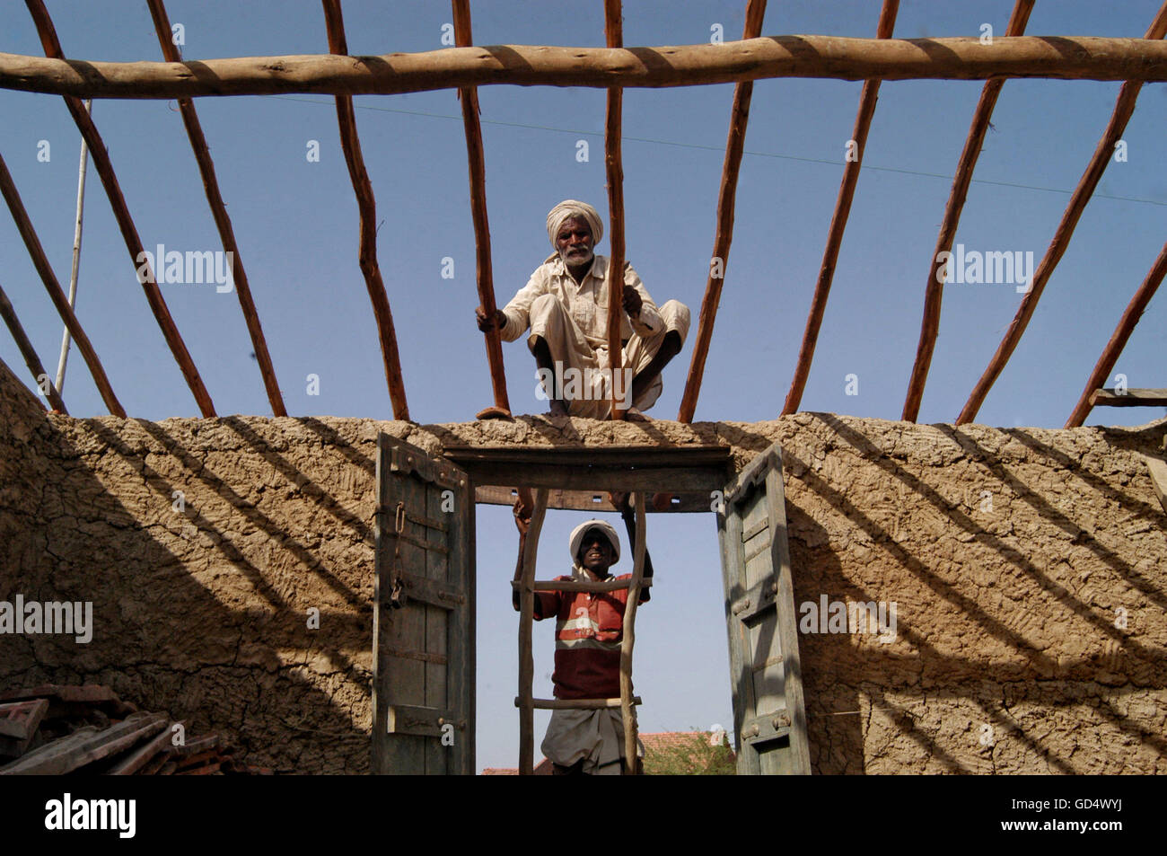Workers building a hut Stock Photo - Alamy
