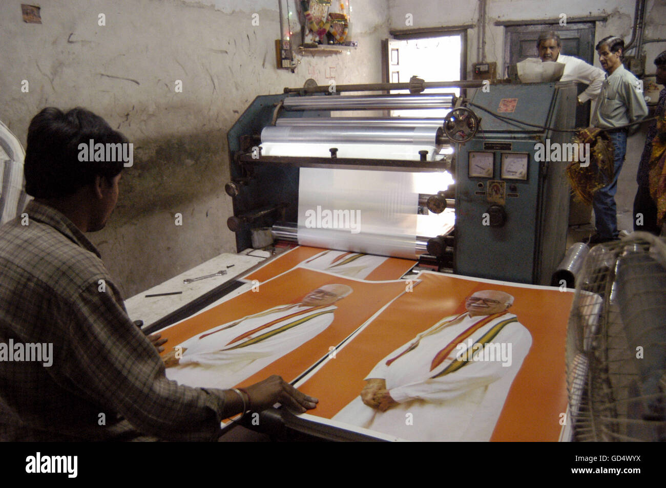Worker prepares poster Stock Photo - Alamy