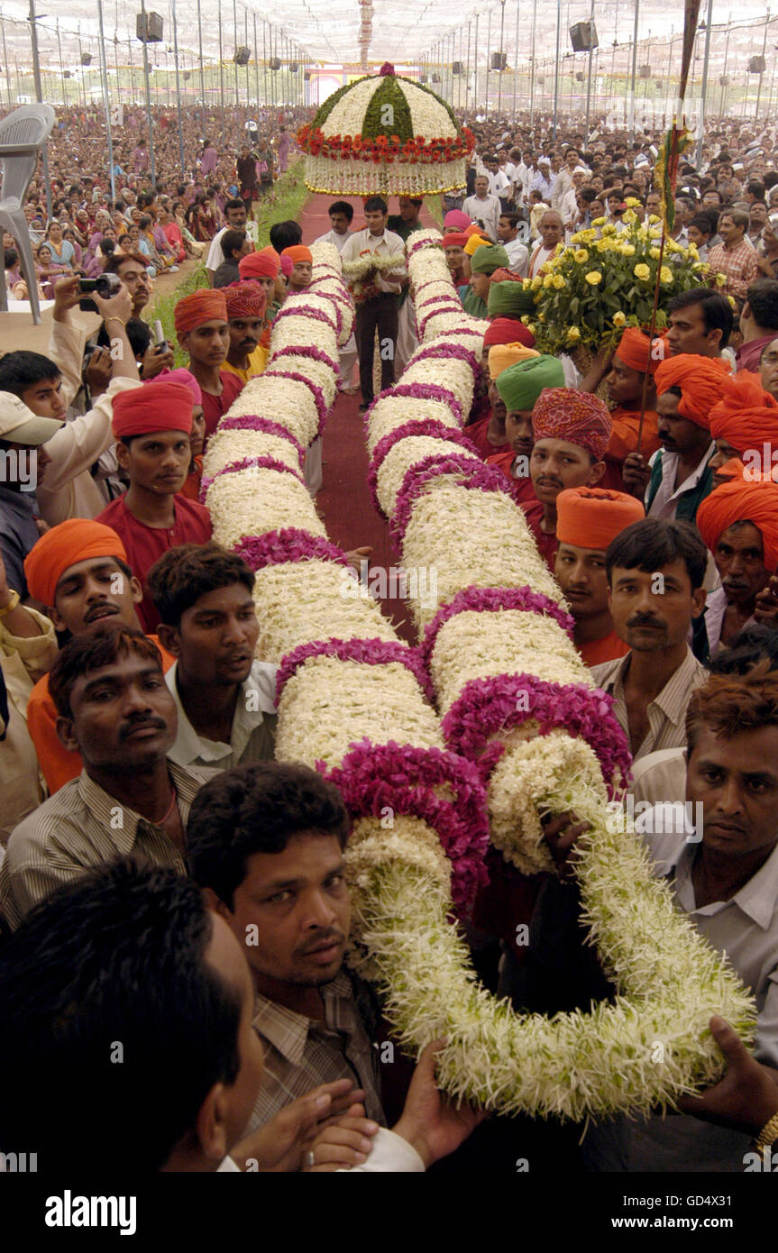 Men carrying huge garland Stock Photo - Alamy
