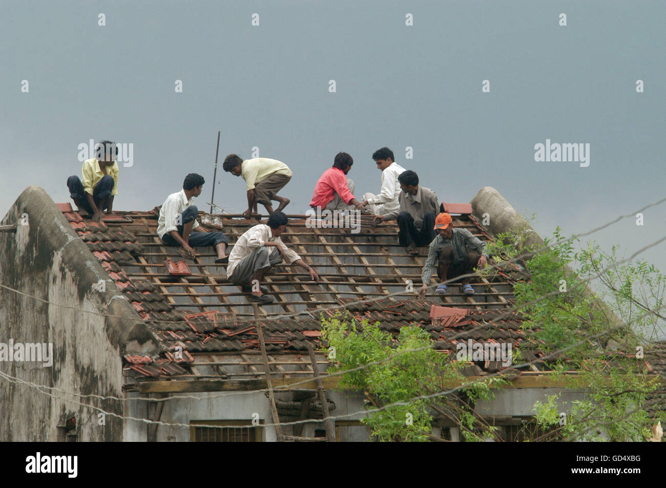 Men reconstructing their houses Stock Photo - Alamy