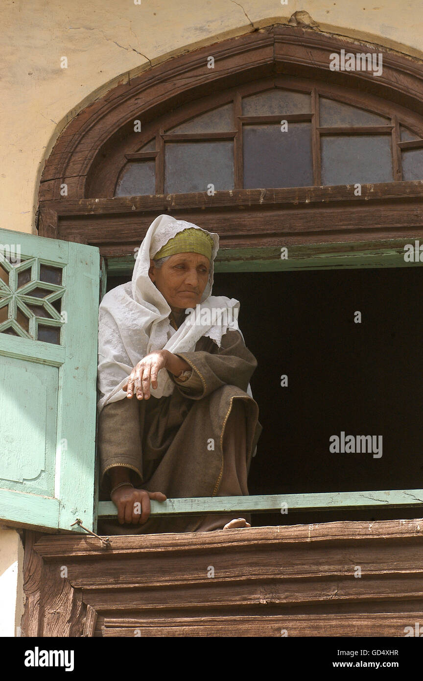 A woman looking from the window Stock Photo - Alamy