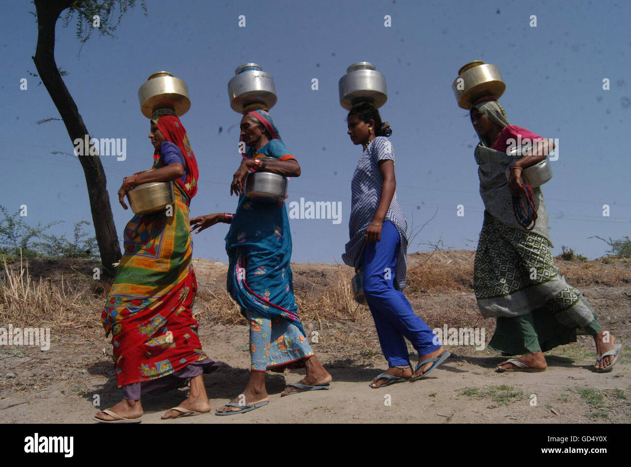 Women carrying water Stock Photo - Alamy