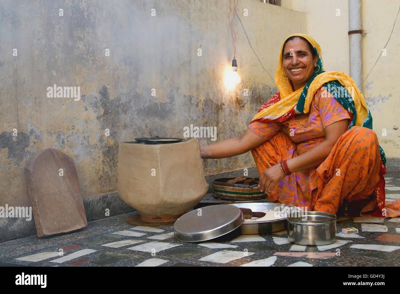 Woman cooking food on a stove Stock Photo - Alamy