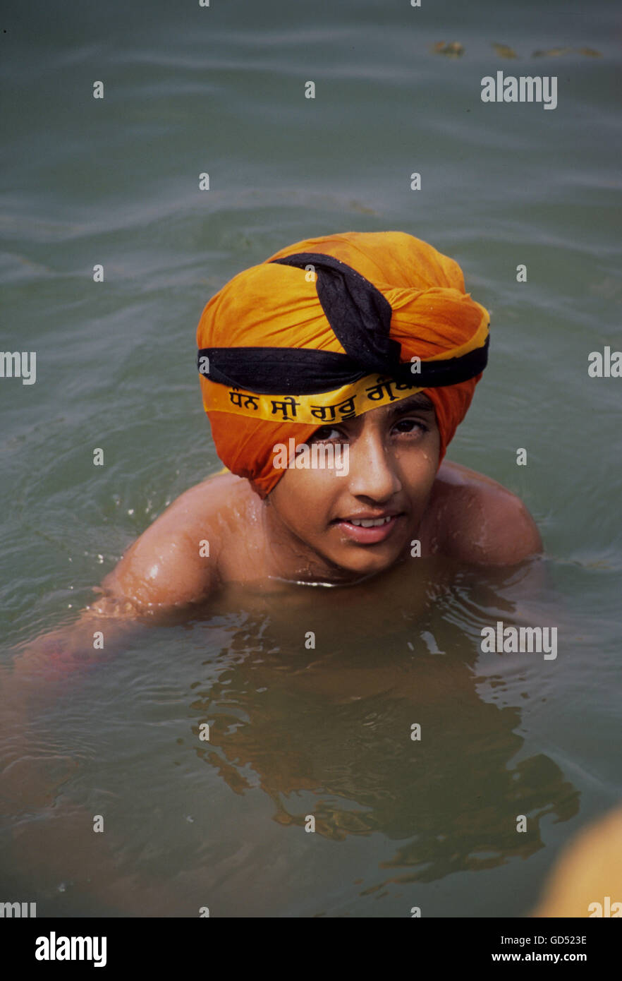 Boy taking holy dip Stock Photo - Alamy