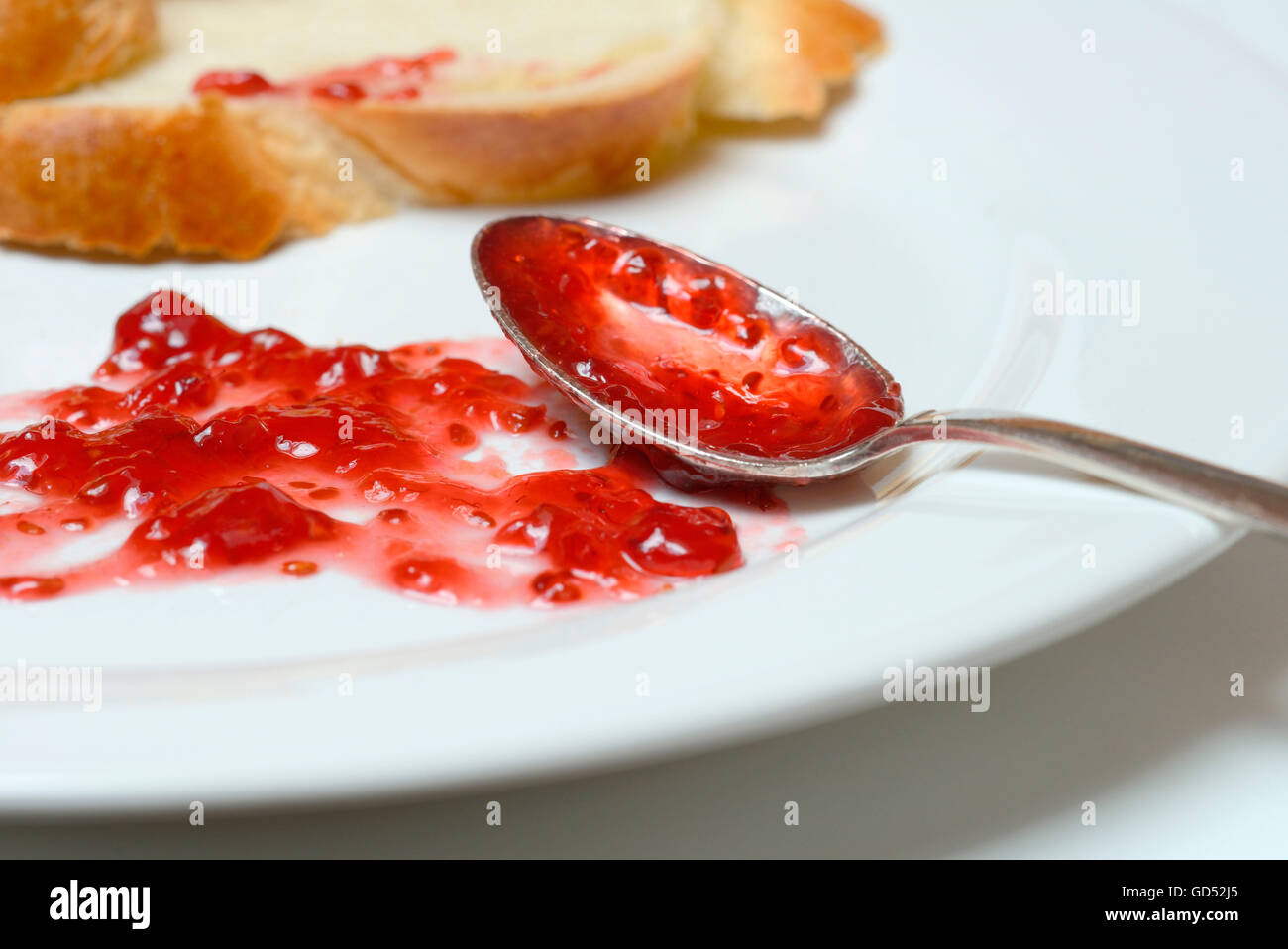 Jam on plate, slice of bread Stock Photo - Alamy