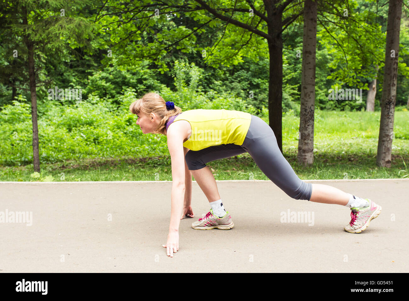 young woman runner getting ready for a run on track Stock Photo - Alamy