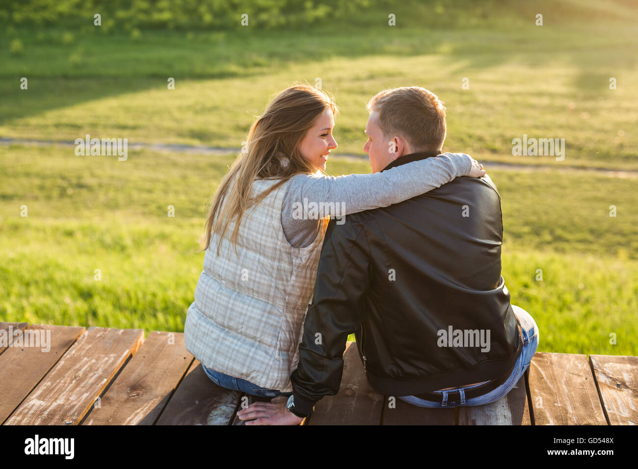 young couple sit and hug together in outdoor Stock Photo - Alamy