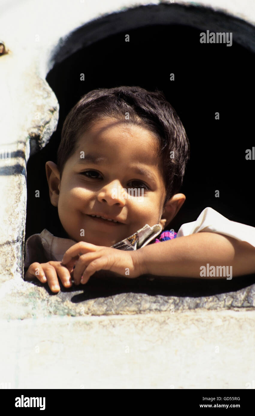 Young boy at a window Stock Photo - Alamy