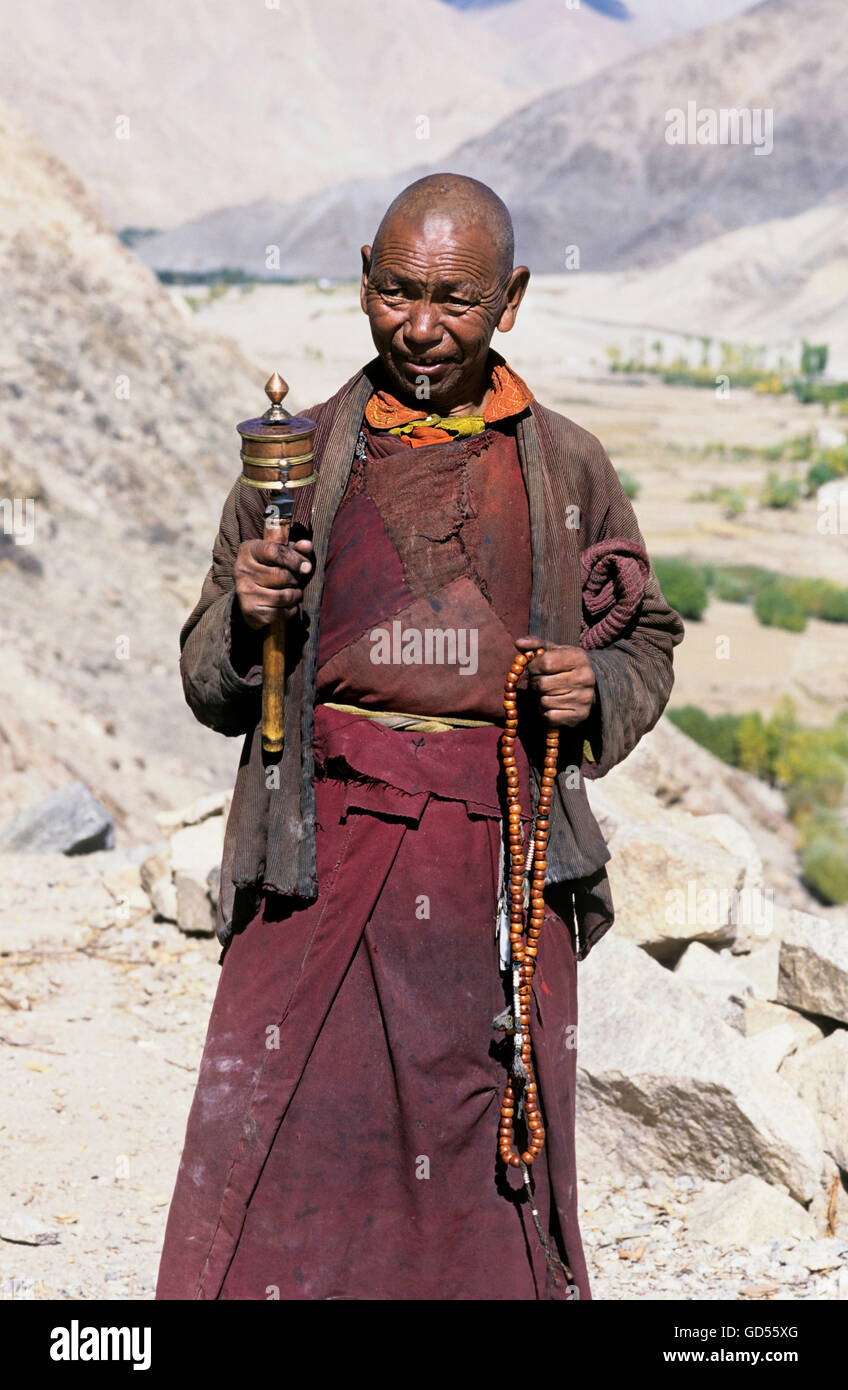 Buddhist monk with a prayer wheel Stock Photo - Alamy