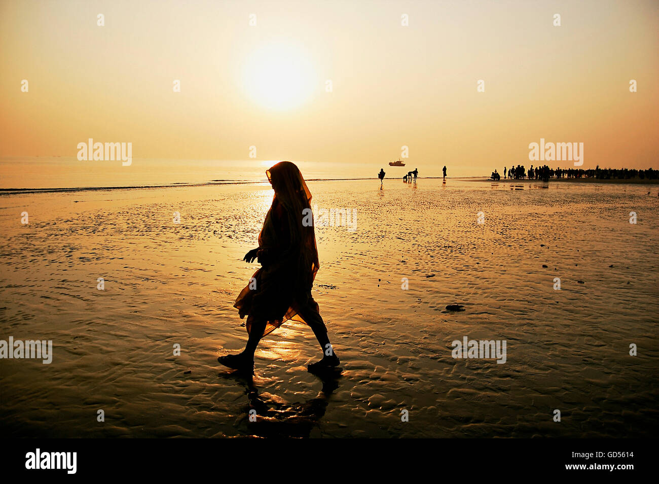 Walking on the beach at sunset Stock Photo - Alamy