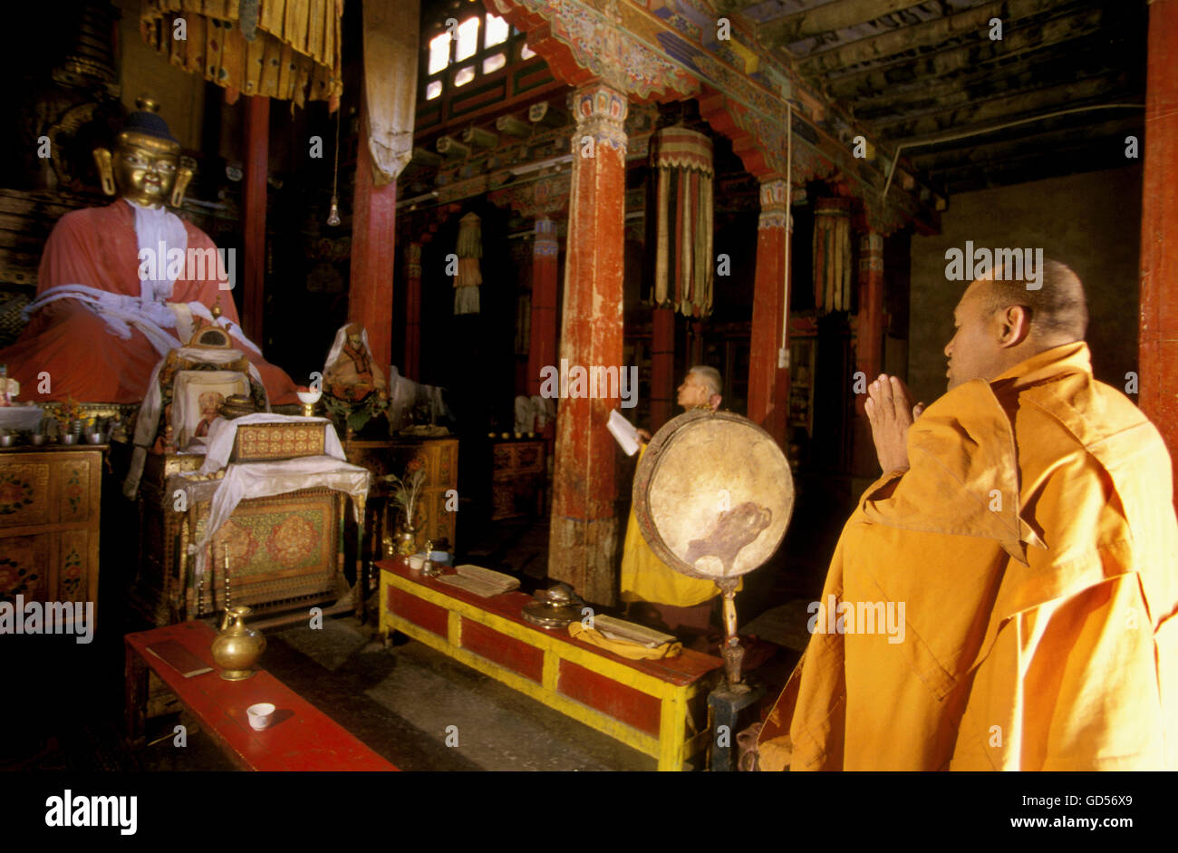 Monk praying in a monastery Stock Photo - Alamy