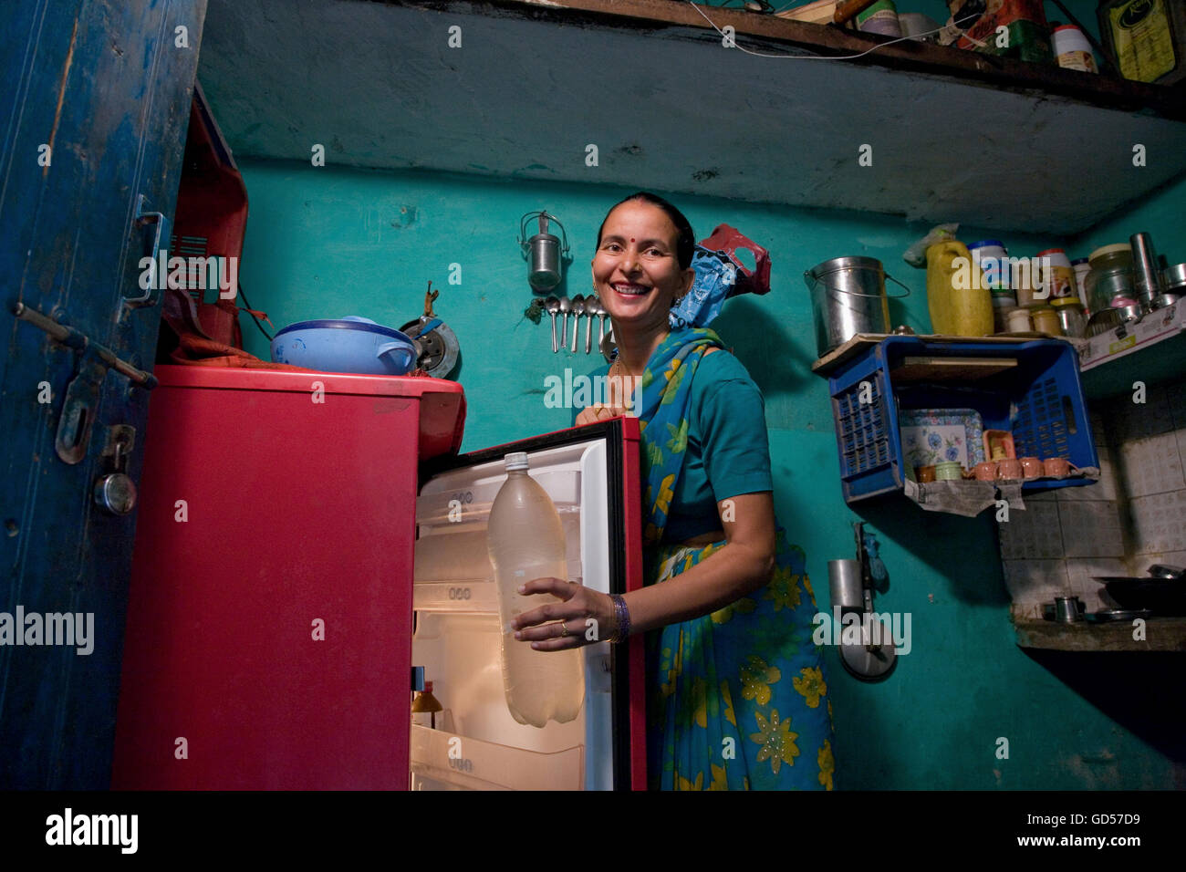 Woman using refrigerator Stock Photo - Alamy