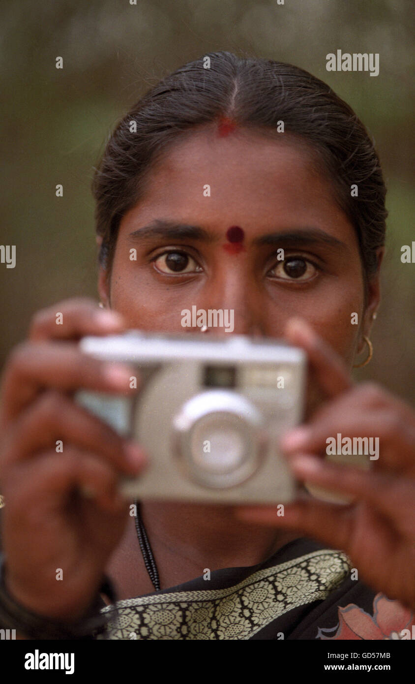Woman clicking a photograph Stock Photo - Alamy