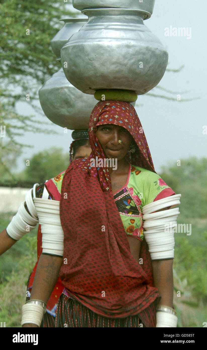 Tribal women carrying water pot Stock Photo - Alamy