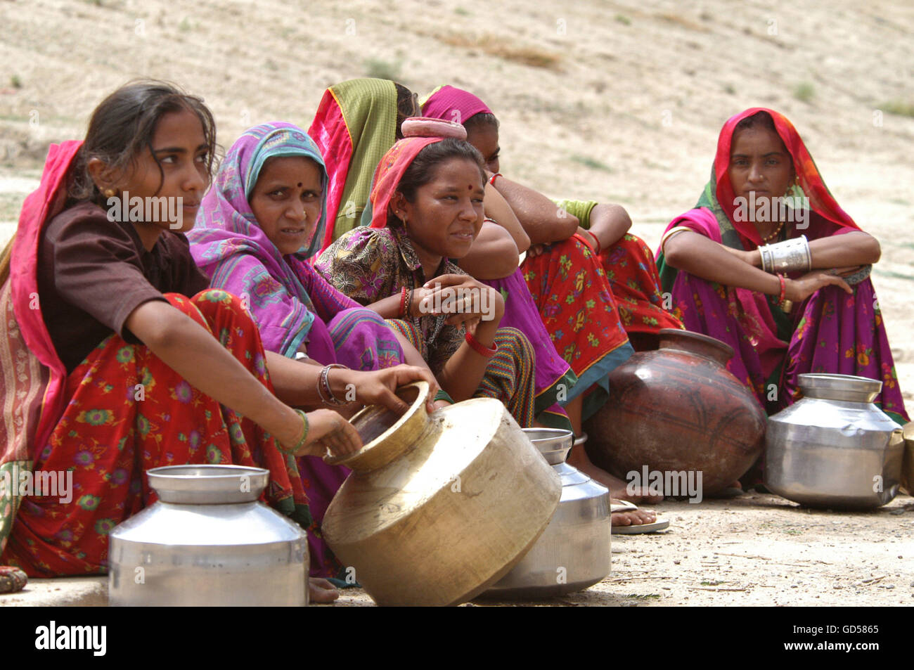 Women sitting with a water pot Stock Photo - Alamy