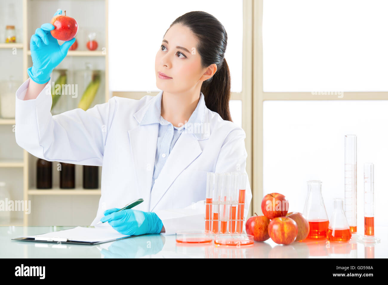 scientist Recording genetic modification data from examining in ...