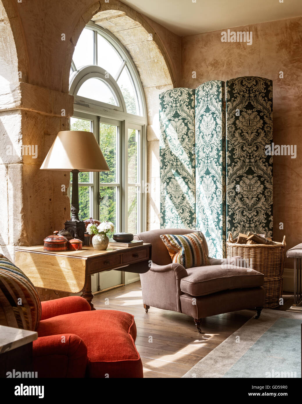 Thistle plaster walls and large arched window in drawing room with ...