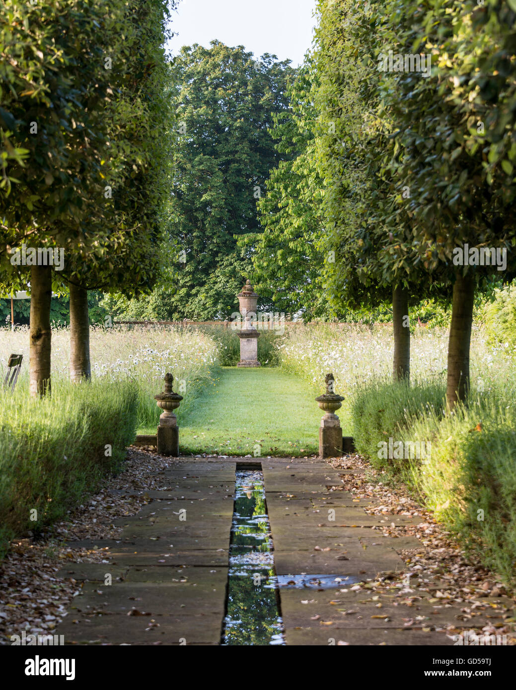 View looking down rill across lawn to stone urn on plinth Stock Photo ...